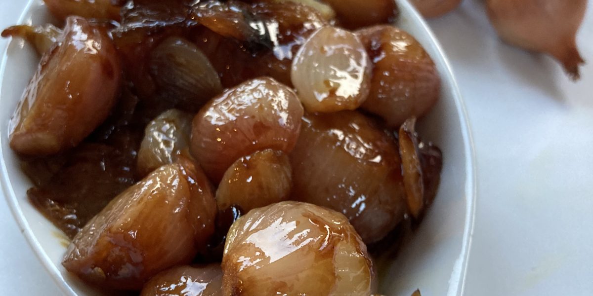 A recipe and instructions for making sticky honey & balsamic shallots