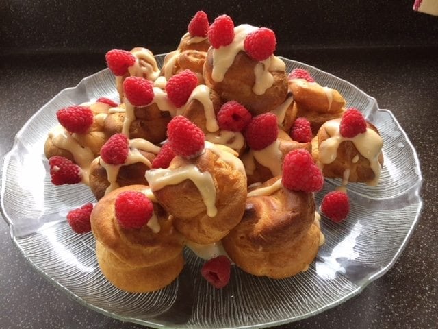 A recipe and instructions for white chocolate & raspberry profiteroles